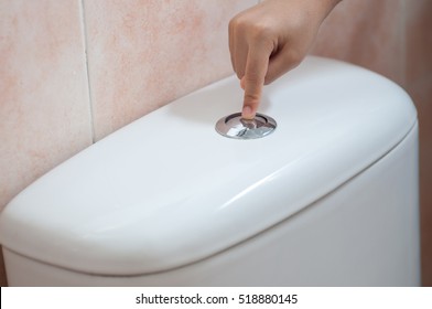 Hand Presses On Button On Toilet Stock Photo (Edit Now) 748329238