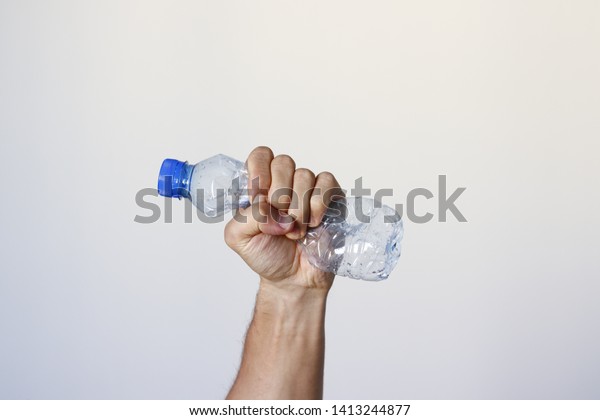 Hand Squeezing Plastic Bottle Representing Movement Stock Photo ...