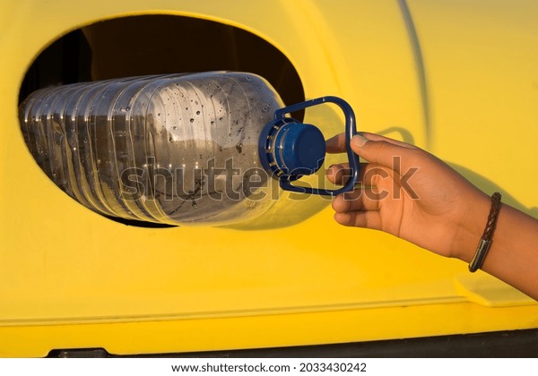 Hand Throwing Plastic Bottle Into Recycling Stock Photo 2033430242 ...