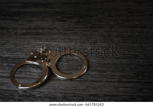 Handcuffs On Dark Rustic Table Stock Photo 665785243 | Shutterstock