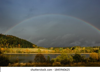 Double Rainbow Over Dark Lake and Forest Landscape premium 2K wallpaper ...