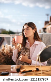 A girl With Her Cat And Drinking Tea 4K wallpaper download