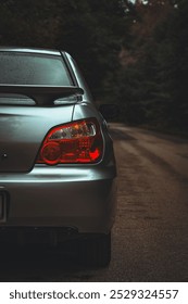 Blue Subaru Impreza on forest road 2K wallpaper download