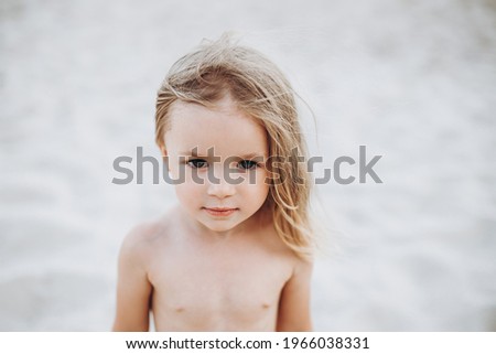 THE CHILD, A LITTLE GIRL POSING ON THE BEACH, SMALL MODEL ON THE BEACH ...