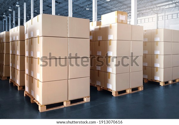 Interior of storage warehouse with stack of card board boxes on pallet ...