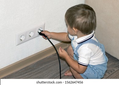 Kid Trying Insert Plug Into Electrical Stock Photo (Edit Now) 1562647456