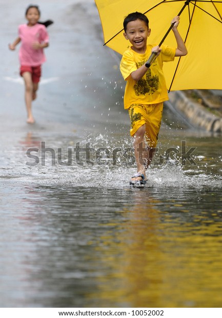 Kids Play While Raining Stock Photo (Edit Now) 10052002