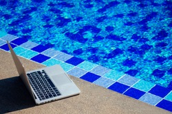 Screen mockup of laptop that a man is using in the pool on vacation ...