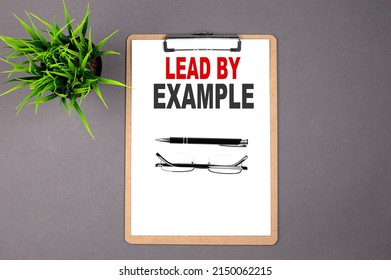 Lead By Example On Brown Clipboard Stock Photo 2150062215 | Shutterstock