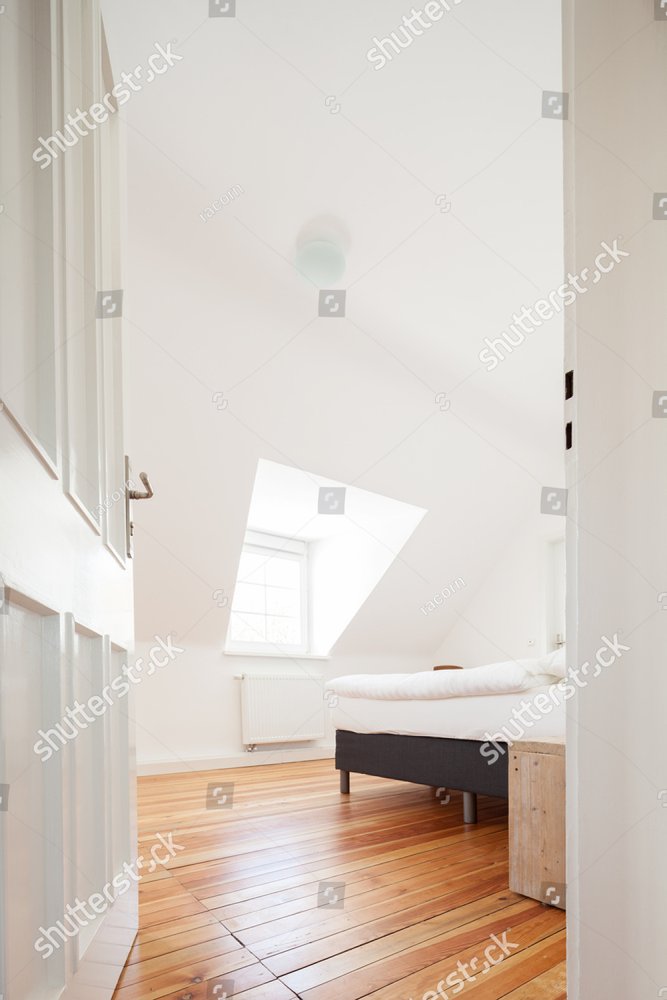 Low angle view through the white painted door into a loft bedroom with ...