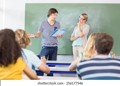 Female Student Explaining Notes Besides Teacher Stock Photo 307293242 ...