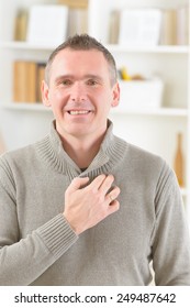 Contented Senior Man Sitting On Sofa Stock Photo (Edit Now) 2075642362