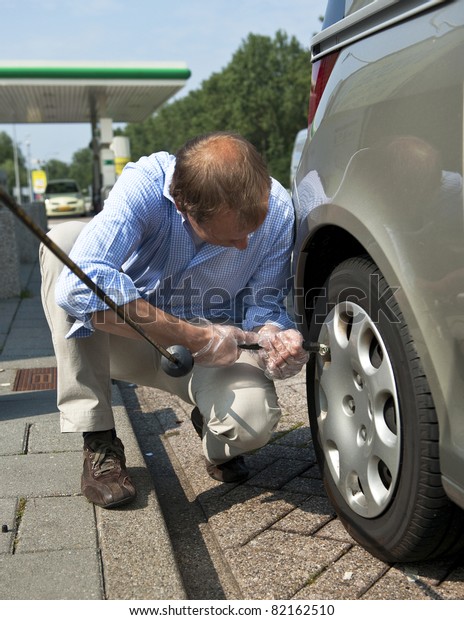 Man Inflating Tire Checking Proper Air Stock Photo (Edit Now) 82162510
