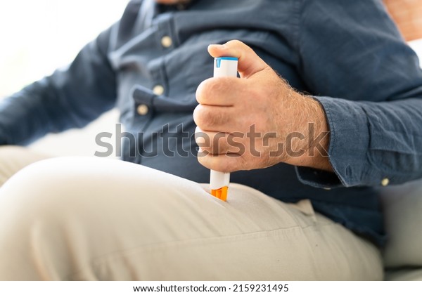 Man Injecting Epinephrine Using Autoinjector Syringe Stock Photo ...