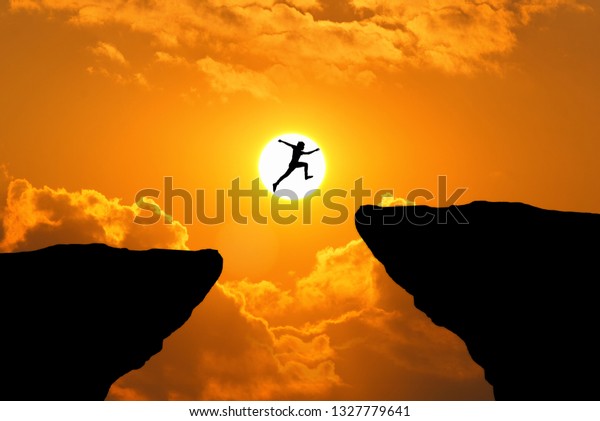 Man Jump Through Gap Between Hill Stock Photo 1327779641 | Shutterstock