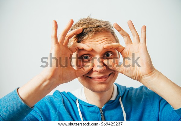 Man Looking Through Hands Making Binoculars Stock Photo 569425237 ...