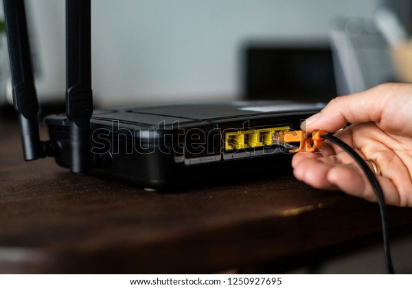 Man Plugging Ethernet Cable Wireless Router Stock Photo 1250927695 ...