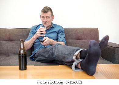 Man Sitting On Couch Drinking Beer Stock Photo (Edit Now) 391162993
