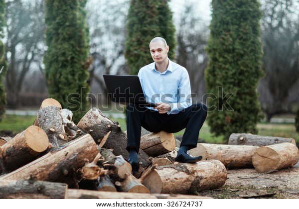 Man Sitting On Log Working On Stock Photo 326724737 | Shutterstock