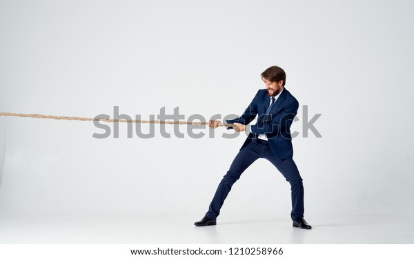 Man Suit Pulls Rope Stock Photo (Edit Now) 1210258966
