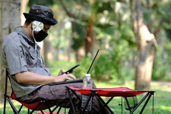White man using laptop featuring activity, alone, and american, a ...