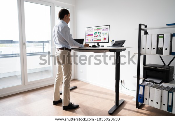 Man Working On Computer Standing Desk Stock Photo (Edit Now) 1835923630