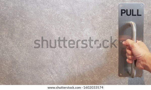 Foto Stok Mans Hand Push Pull Door Handles (Edit Sekarang) 1602033574