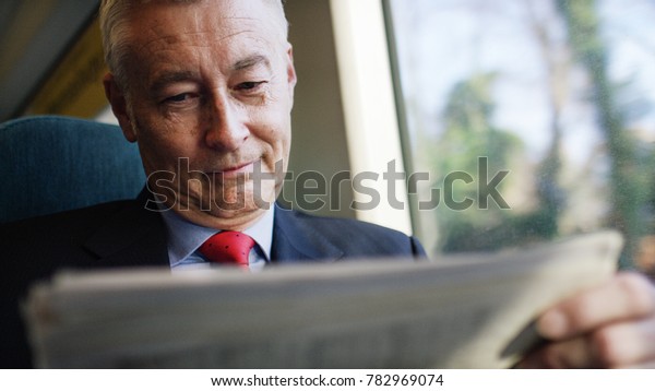 Mature Business Investor Reading Newspaper During Stock Photo (Edit Now ... Mature Business Investor Reading Newspaper During Stock Photo (Edit Now ...