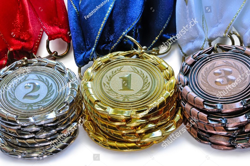 Metal medals for the first second and third place with ribbons of red ...