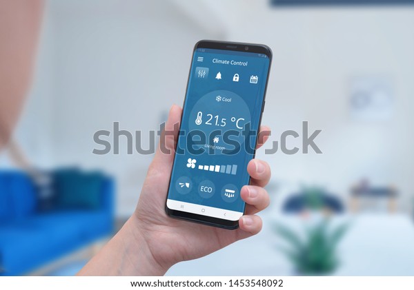 Modern climate control app interface on a smartphone in hand. Concept ...
