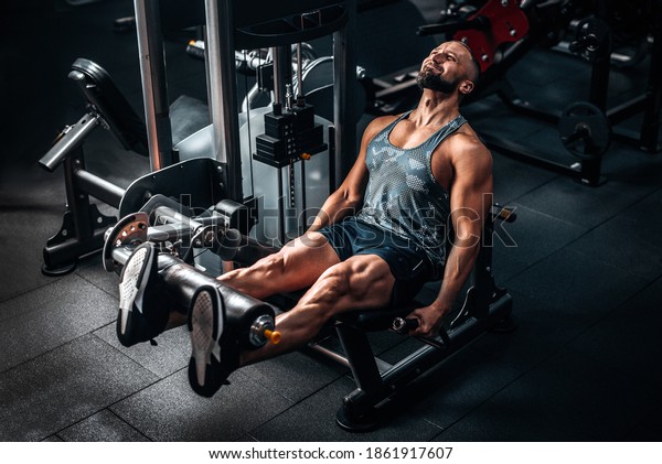 Muscular Man Using Weights Machine Legs Stock Photo (Edit Now) 1861917607
