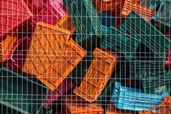 Black plastic boxes in a warehouse containing pile, box, and plastic ...