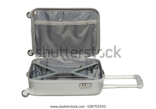 Opened silver suitcase lying on the floor, isolated on white background