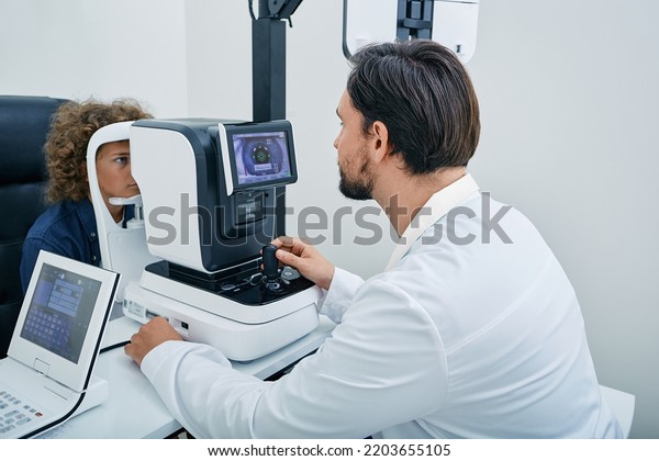 Optometrist Using Autorefractor Determining Required Level Stock Photo ...