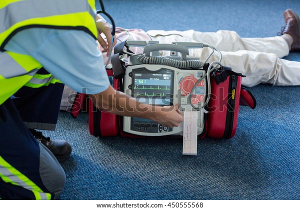 Paramedic Using External Defibrillator During Cardiopulmonary Stock ...