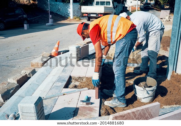 Pavement Construction Workers Installing Tiles Build Stock Photo ...