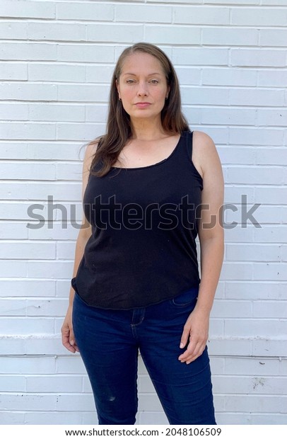 Plus Size Curve Curvy Women Model In Vest And Skinny Jeans Against