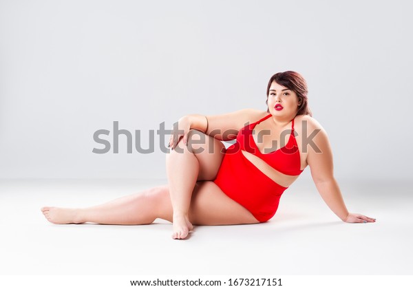 Plus Size Fashion Model In Red Swimsuit Fat Woman In Lingerie On Gray