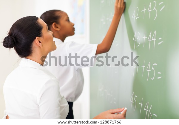 Primary School Maths Teacher Teaching Student Stock Photo Edit Now primary-school-maths-teacher-teaching-student-stock-photo-edit-now