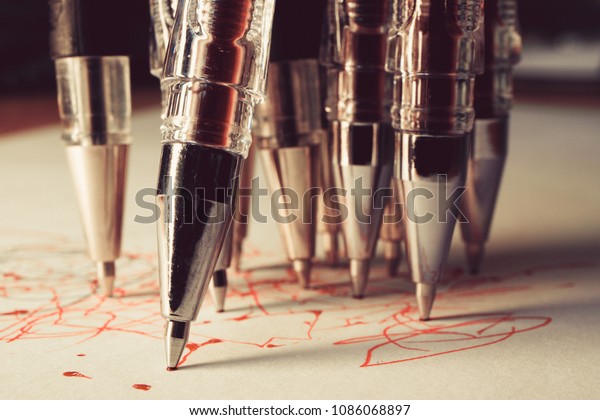 Red Pens Write Simultaneously On White Stock Photo (Edit Now) 1086068897