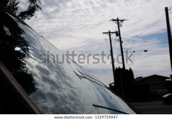 Reflection of fall sky in car windshield. - Stock Image - Everypixel