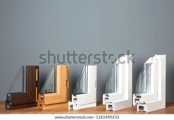 Samples of modern window profiles on table against gray wall ...