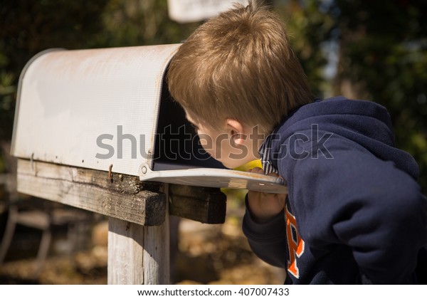 School boy opening a post box and checking mail. Kid waiting for a ...