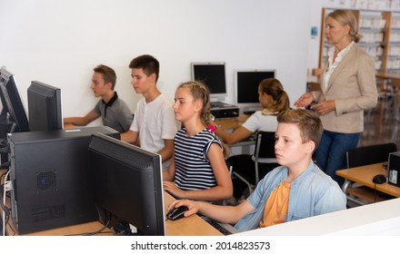 Schoolchildren Using Computers Teacher Teaching Them Stock Photo ...
