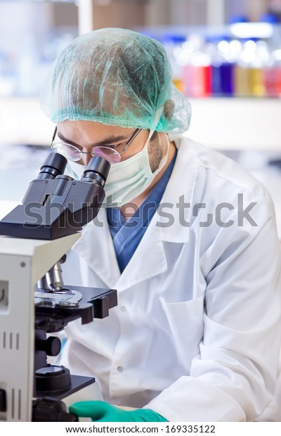 Scientist Laboratory Looking Down Microscope He Stock Photo 169335122 ...
