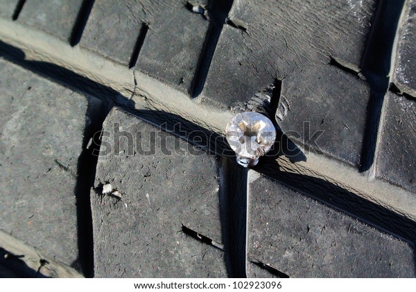 Screw Puncturing Tire Stock Photo 102923096 | Shutterstock