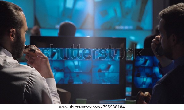 Security Guards Eating Donuts While Watching Stock Photo (Edit Now ...