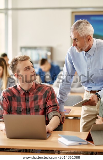 Senior Teacher Using Touchpad While Communicating Stock Photo ...