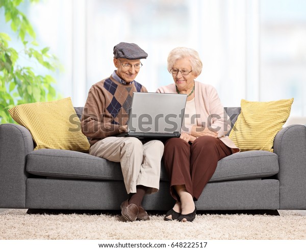 Seniors Sitting On Sofa Using Laptop Stock Photo 648222517 | Shutterstock