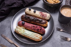 Set of different eclair cakes on dar stock photo containing top view ...